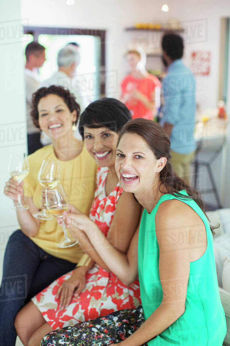 Women smiling together at party - Stock Photo - Dissolve