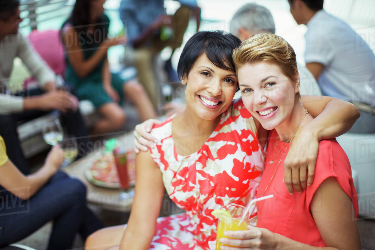 Women hugging at party - Royalty-free Stock Photo | Dissolve