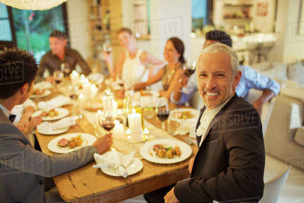 Man smiling at dinner party - Royalty-free Stock Photo | Dissolve