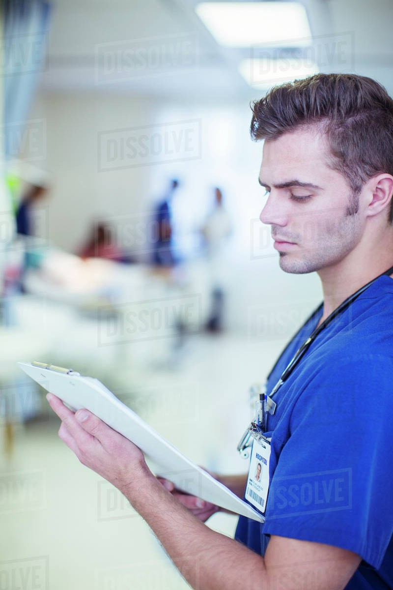 Nurse reading medical chart in hospital - Royalty-free Stock Photo ...