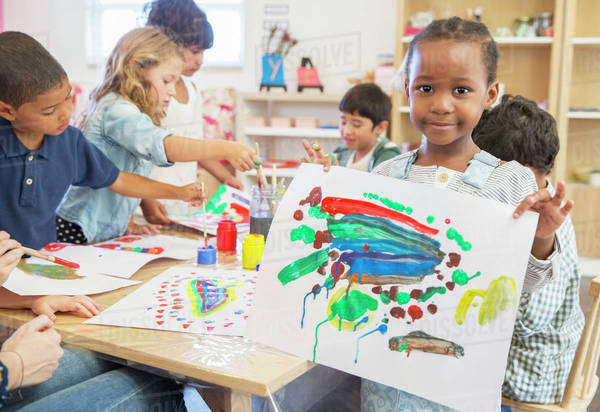 Student showing off finger painting in classroom - Royalty-free Stock ...
