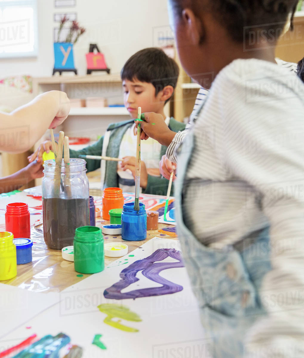 Students painting in classroom - Royalty-free Stock Photo | Dissolve