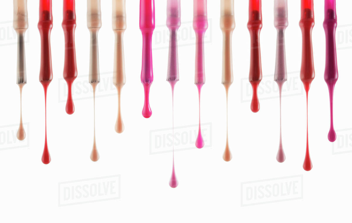 Close up of multicolor fingernail polish dripping from brushes - Stock ...