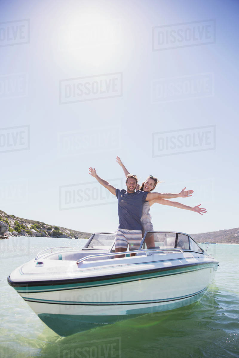 Couple playing on speedboat - Stock Photo - Dissolve