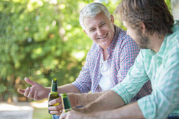 Father and son drinking outdoors - Royalty-free Stock Photo | Dissolve
