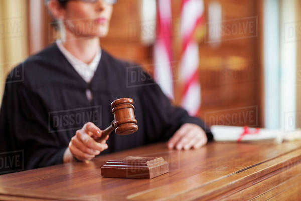 Judge banging gavel in court - Stock Photo - Dissolve