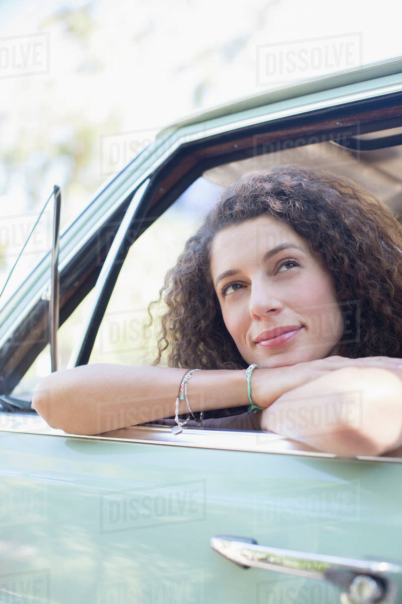 Woman relaxing on car door during car ride - Royalty-free Stock Photo ...