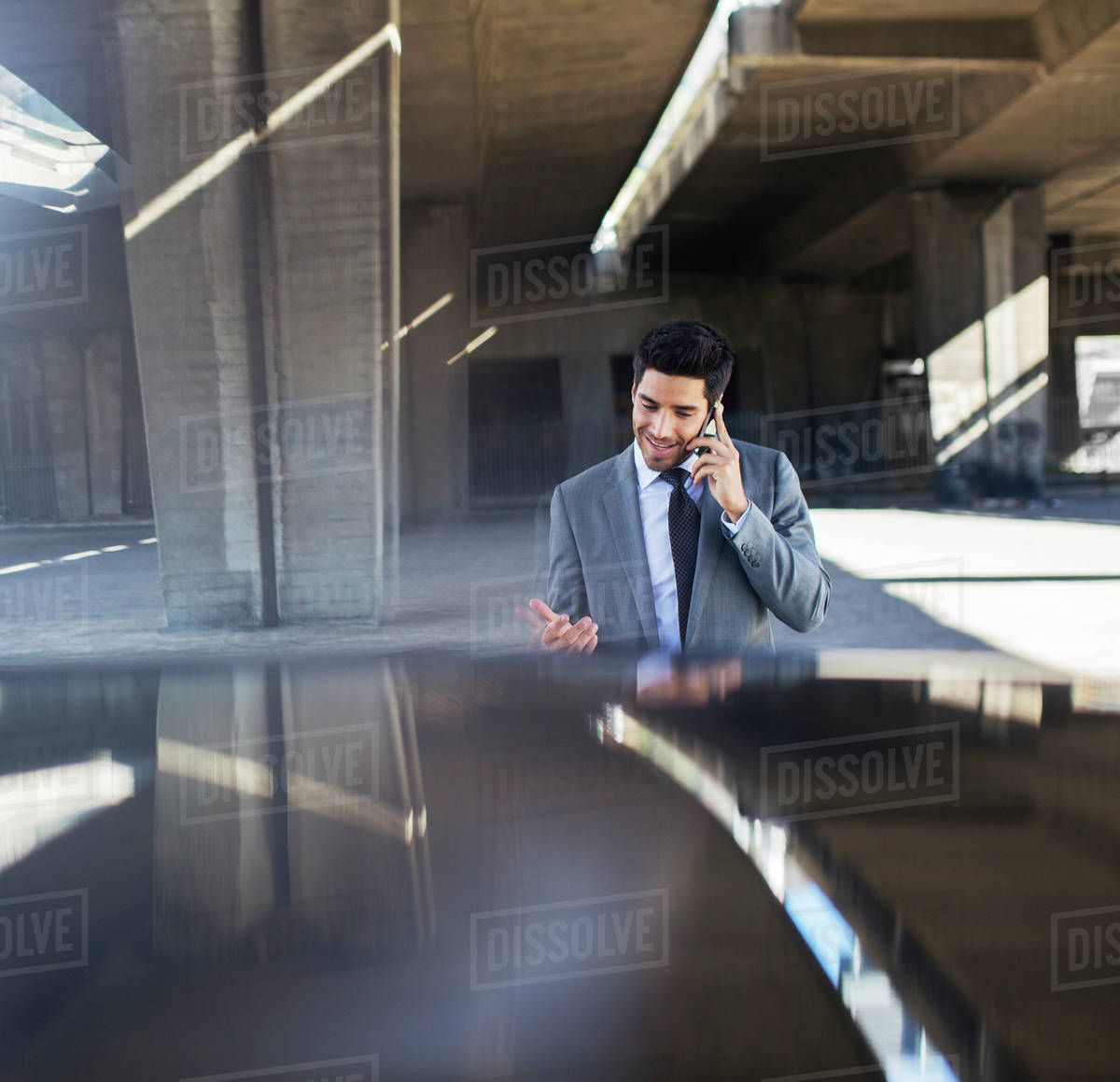 Businessman talking on cell phone in parking garage - Stock Photo ...