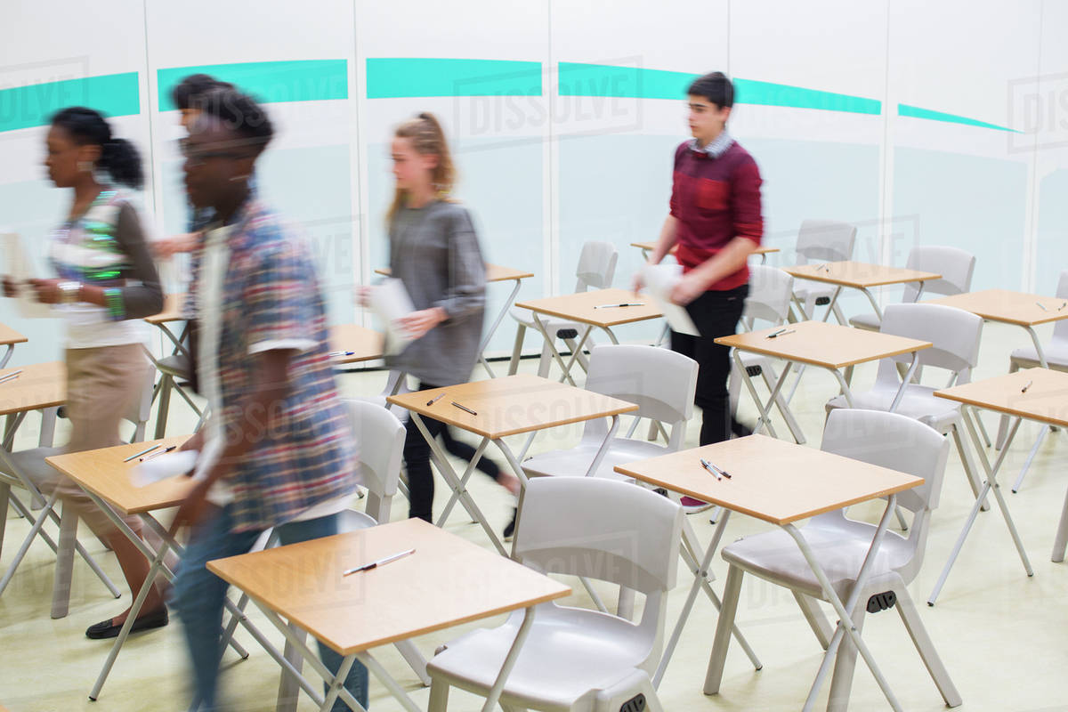 Students going out of classroom after lesson - Stock Photo - Dissolve
