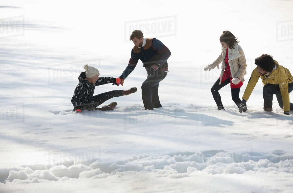 Friends playing in snow - Royalty-free Stock Photo | Dissolve