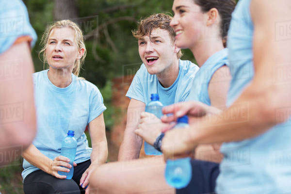 Tired team resting and drinking water at boot camp - Royalty-free Stock ...