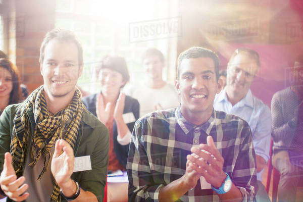 Portrait of smiling audience clapping - Stock Photo - Dissolve