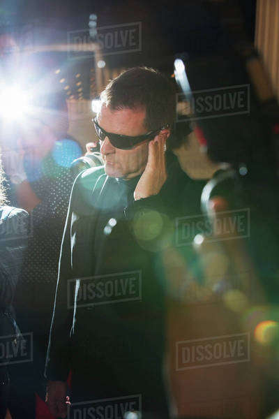 Bodyguard listening to earpiece at event - Royalty-free Stock Photo ...