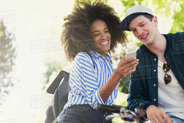 Friends texting with cell phone - Royalty-free Stock Photo | Dissolve