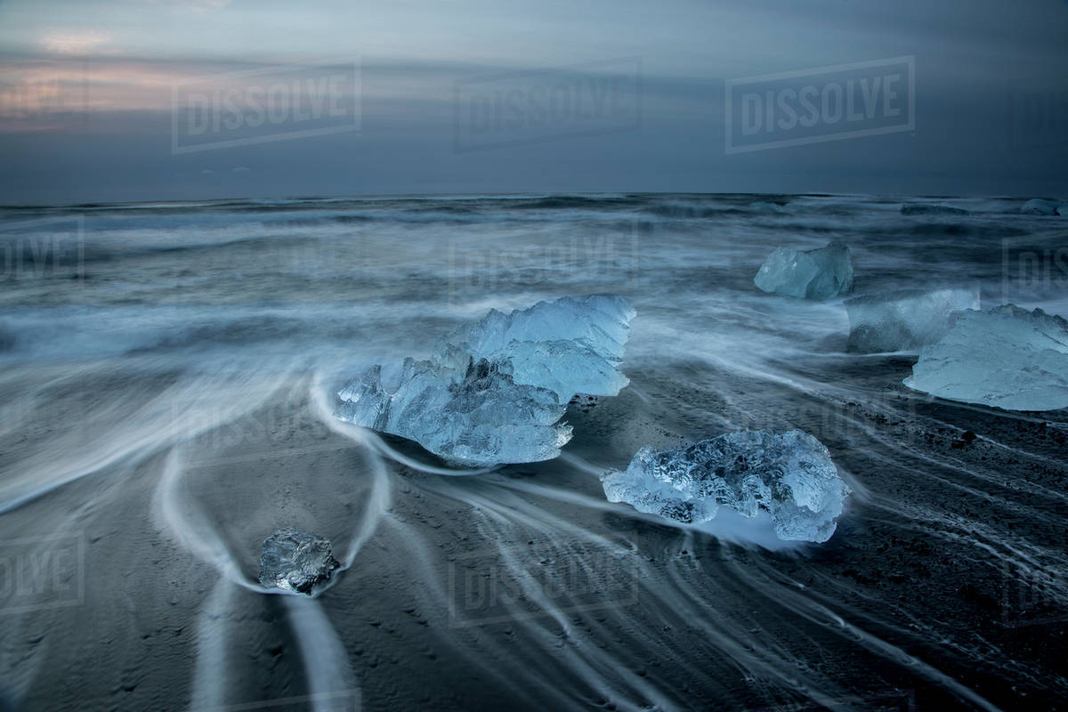 Long exposure of ice on cold stormy ocean beach, Jokulsarlon, Iceland ...