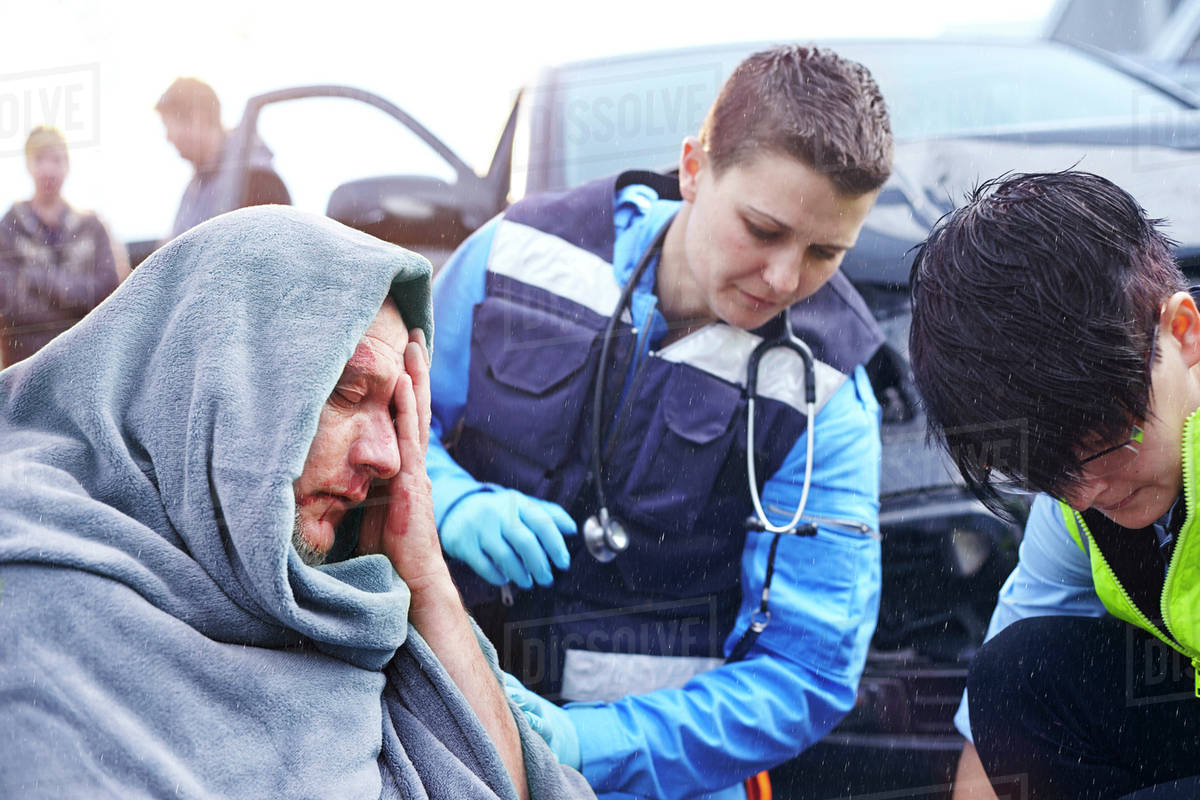 Rescue workers tending to car accident victim - Royalty-free Stock ...