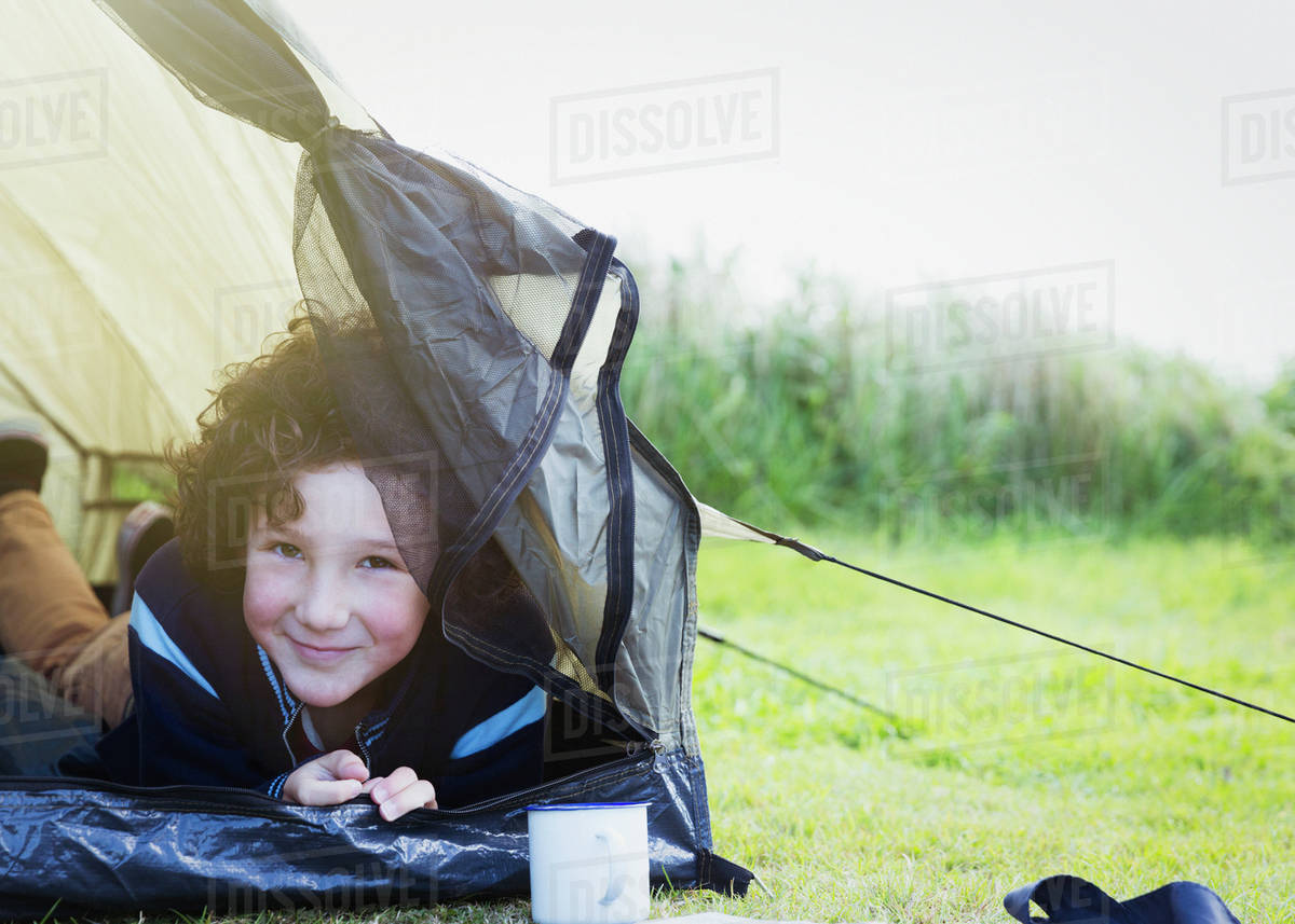 Portrait smiling boy inside tent - Stock Photo - Dissolve