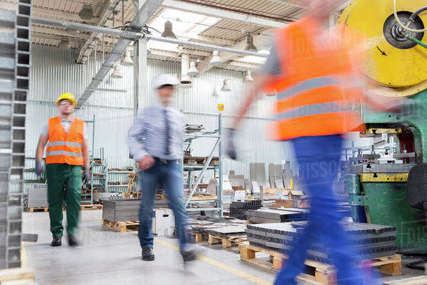 Engineer and works walking in factory - Royalty-free Stock Photo | Dissolve