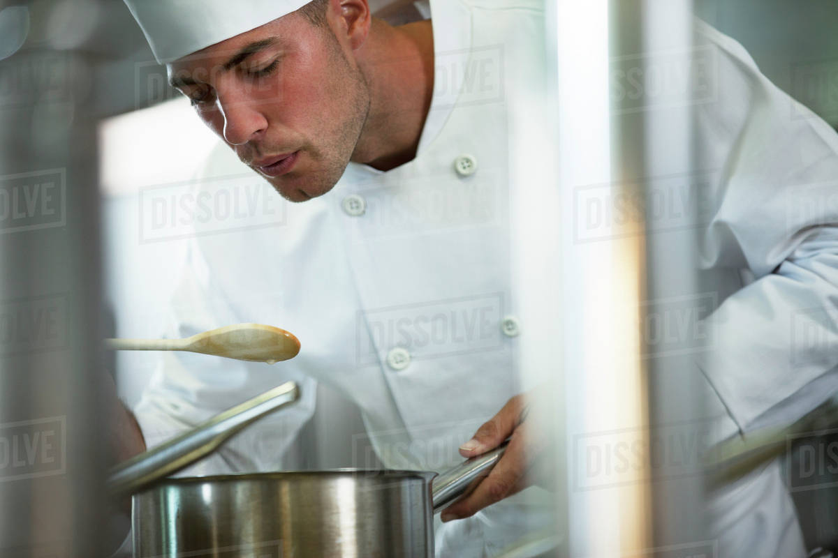 Chef tasting food in restaurant kitchen - Stock Photo - Dissolve