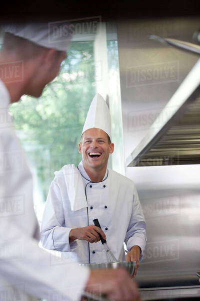 Chefs talking in restaurant kitchen - Stock Photo - Dissolve