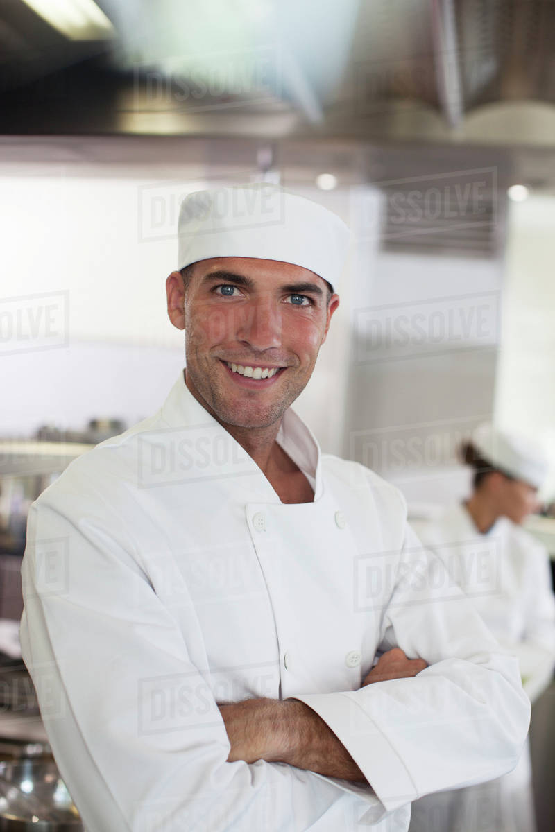 Chef smiling in restaurant kitchen - Stock Photo - Dissolve