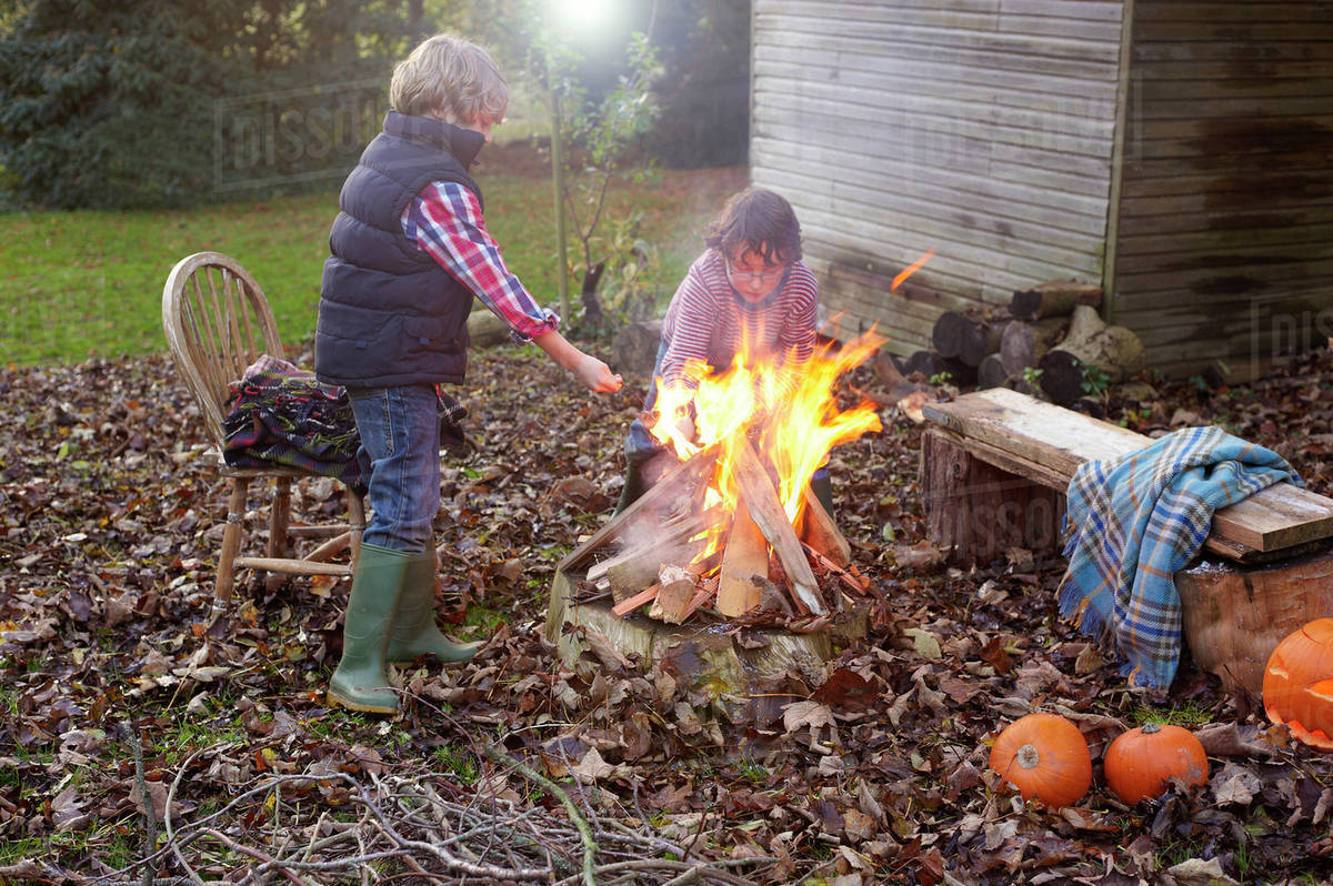 Children building bonfire outdoors - Royalty-free Stock Photo | Dissolve