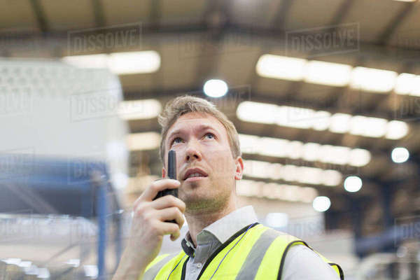 Supervisor using walkie-talkie in steel factory - Royalty-free Stock ...