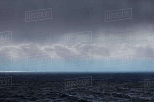 Clouds and rain over ocean seascape - Stock Photo - Dissolve