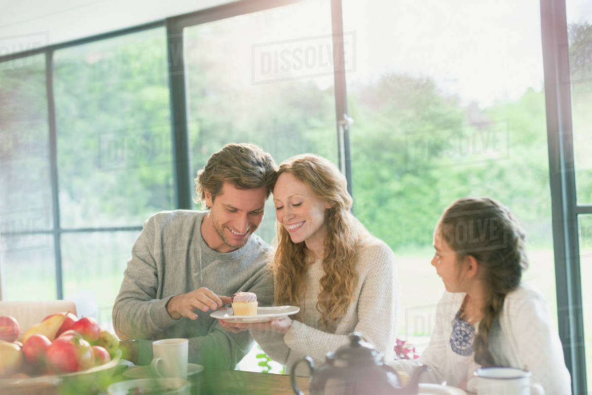 Family sharing cupcake - Royalty-free Stock Photo | Dissolve