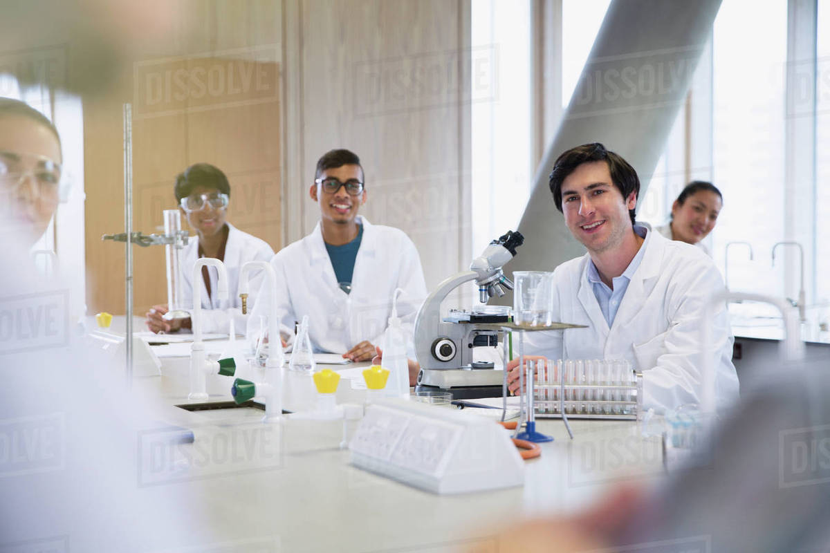 Portrait smiling college students in science laboratory classroom ...