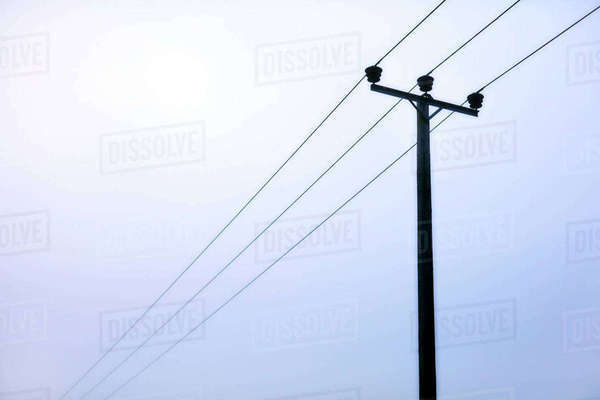 Power lines under overcast sky - Royalty-free Stock Photo | Dissolve
