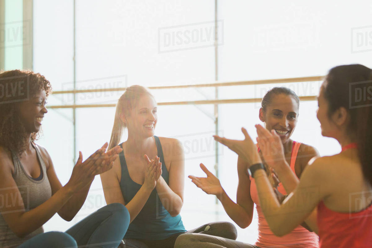 Smiling women clapping in exercise class gym studio - Royalty-free ...