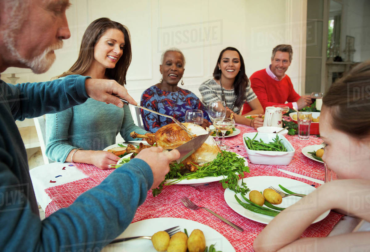 Family enjoying Christmas turkey dinner at table - Royalty-free Stock ...