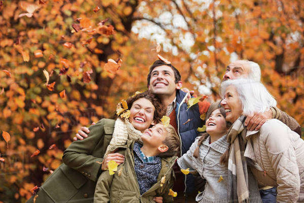 Family playing in autumn leaves in park - Royalty-free Stock Photo ...