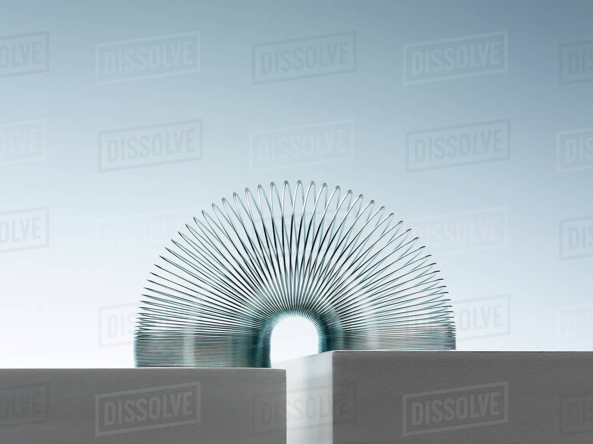 Metal slinky spanning space between blocks - Royalty-free Stock Photo ...
