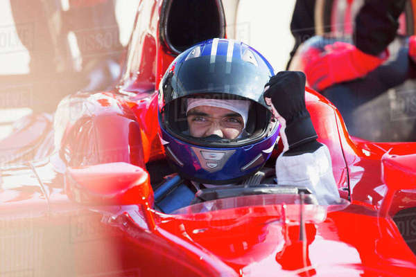 Formula one race car driver in helmet gesturing, celebrating victory ...