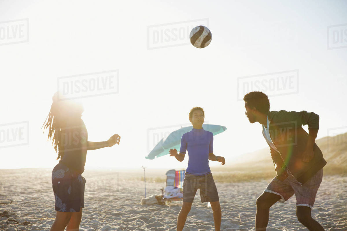 Family playing soccer on sunny summer beach - Royalty-free Stock Photo ...