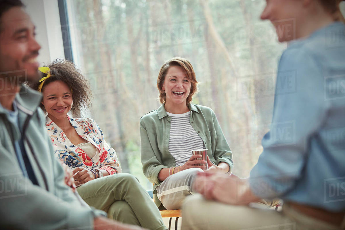 People smiling and laughing in group therapy session - Royalty-free ...