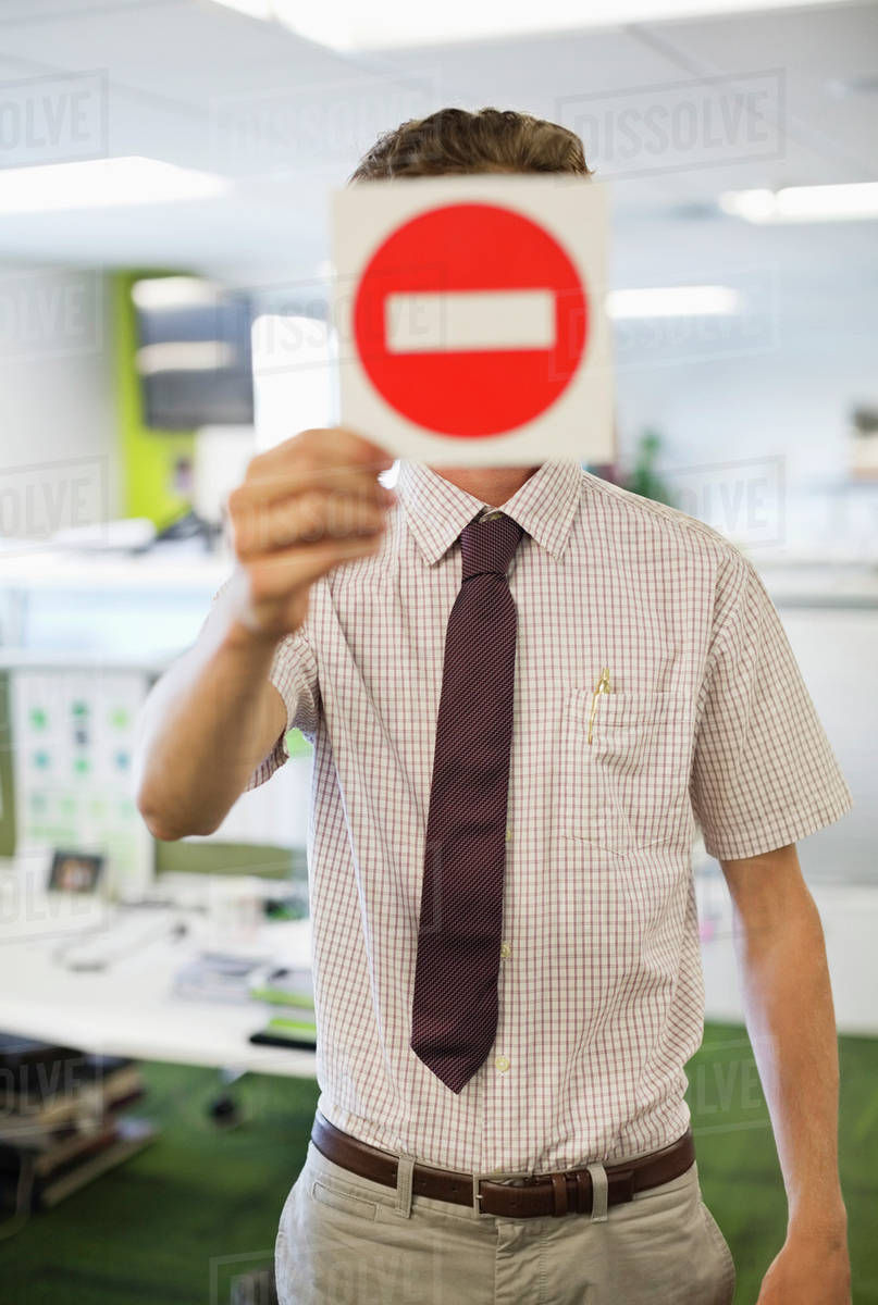 Businessman holding warning sign in office - Royalty-free Stock Photo ...