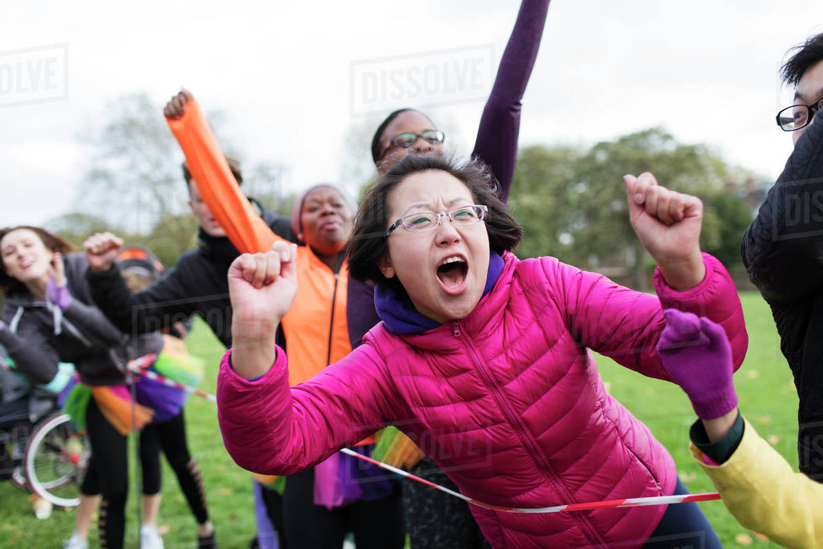 Enthusiastic female spectator cheering at charity run in park - Royalty ...