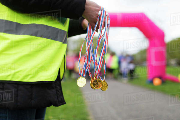 Volunteer holding medals at charity run - Royalty-free Stock Photo ...