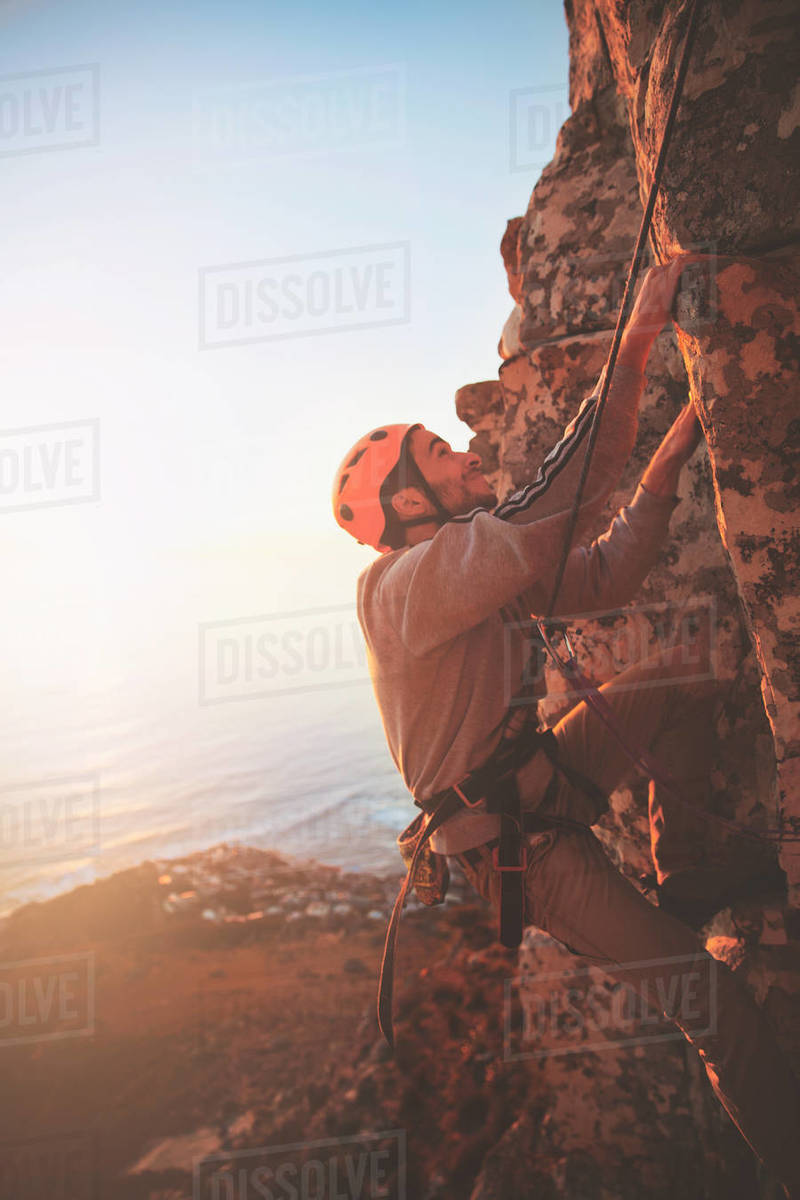 Male rock climber scaling rock - Royalty-free Stock Photo | Dissolve