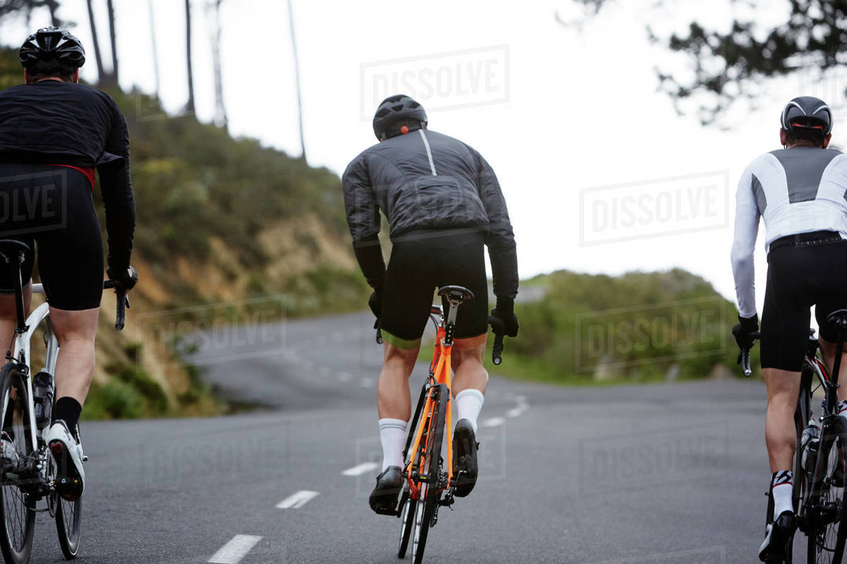 Male cyclists cycling on road - Royalty-free Stock Photo | Dissolve