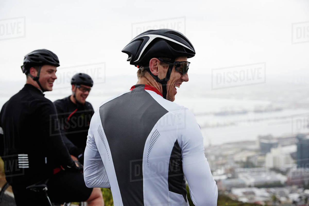 Smiling male cyclist friends taking a break - Royalty-free Stock Photo ...