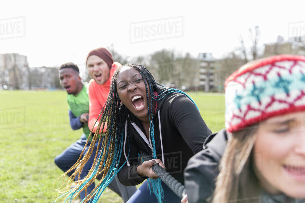 Determined team pulling rope in tug-of-war - Royalty-free Stock Photo ...