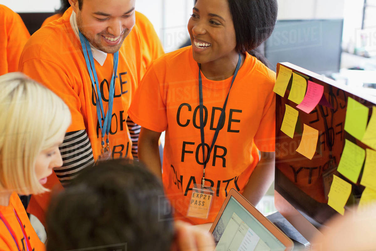 Hackers coding for charity at hackathon - Stock Photo - Dissolve