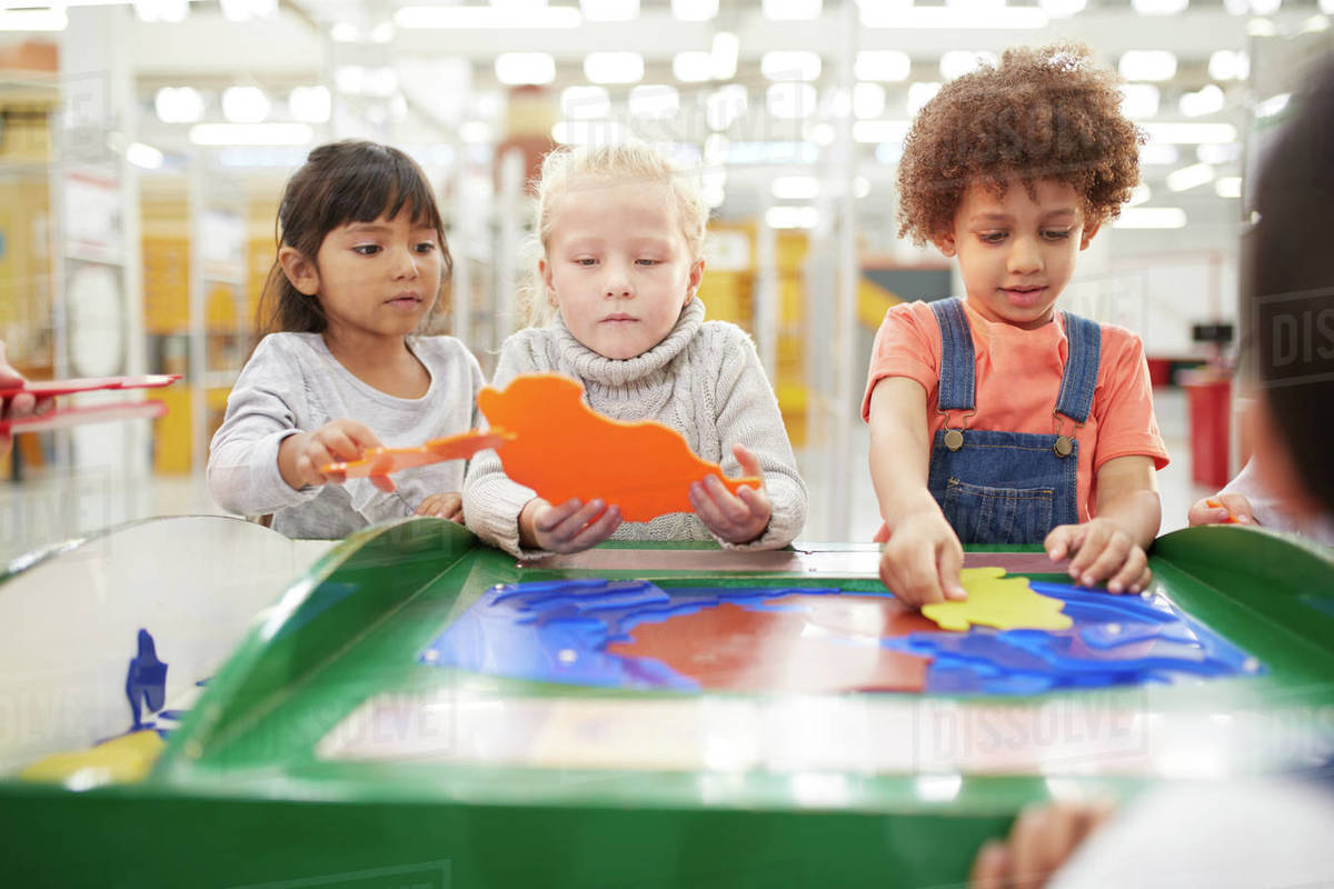 Kids playing at interactive exhibit in science center - Royalty-free ...