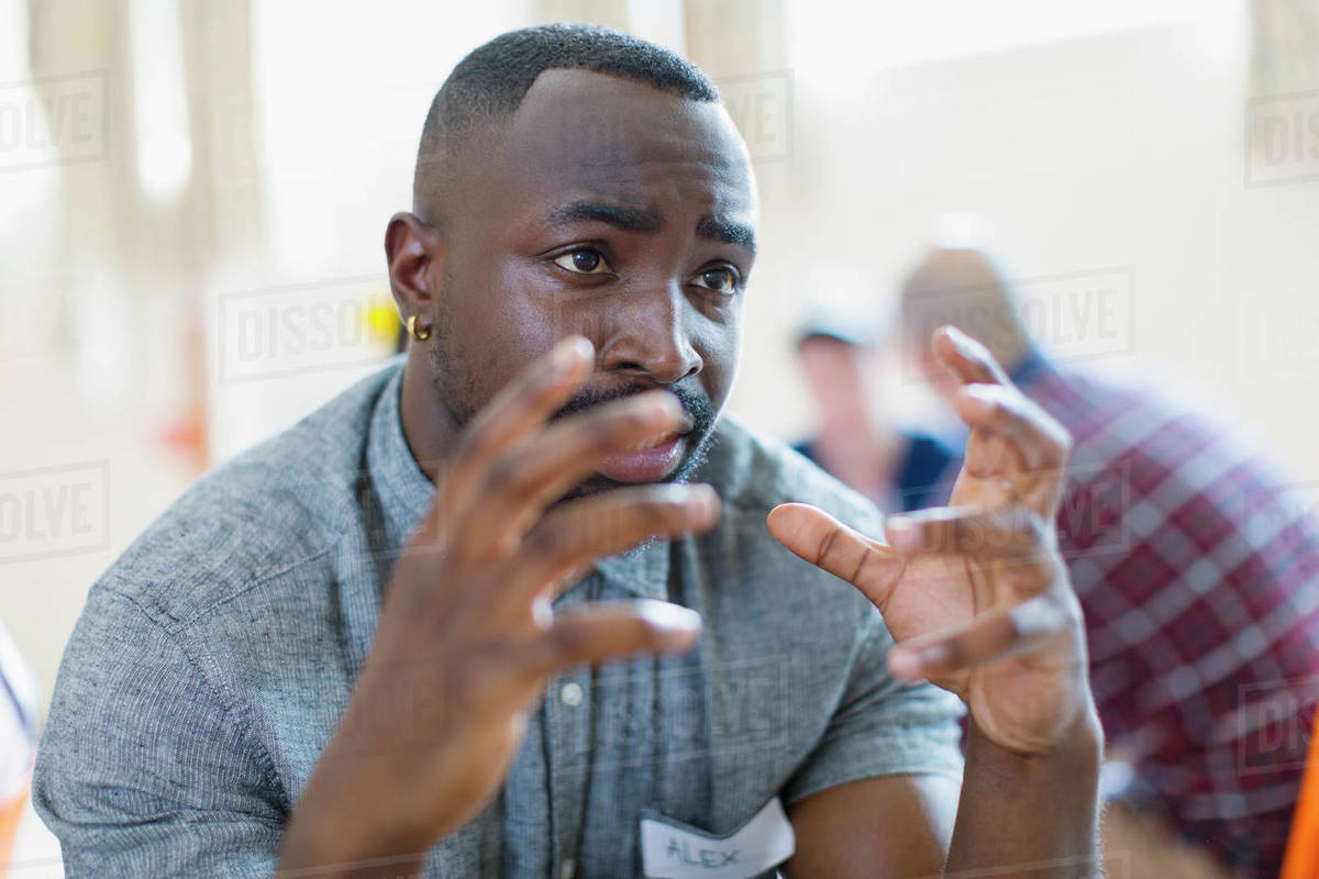 Serious young man talking, gesturing in group therapy - Royalty-free ...