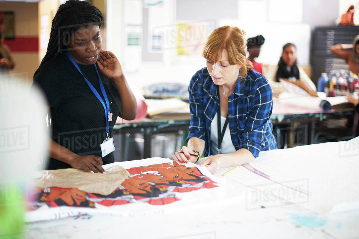 Female artists looking at screen print in art studio - Royalty-free ...