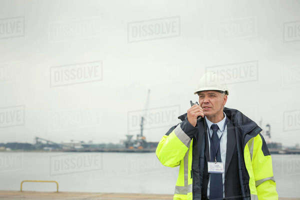 Dock manager using walkie-talkie at commercial dock - Royalty-free ...
